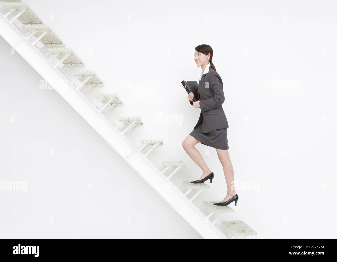 Woman walking up stairs side view hi-res stock photography and images ...