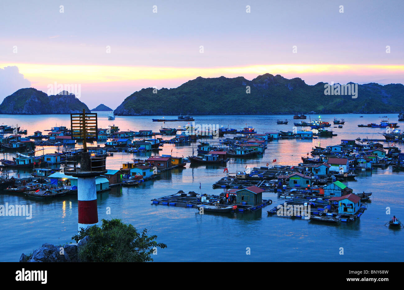 Boats and floating houses in front of Cat Ba Town, on Cat Ba Island ...