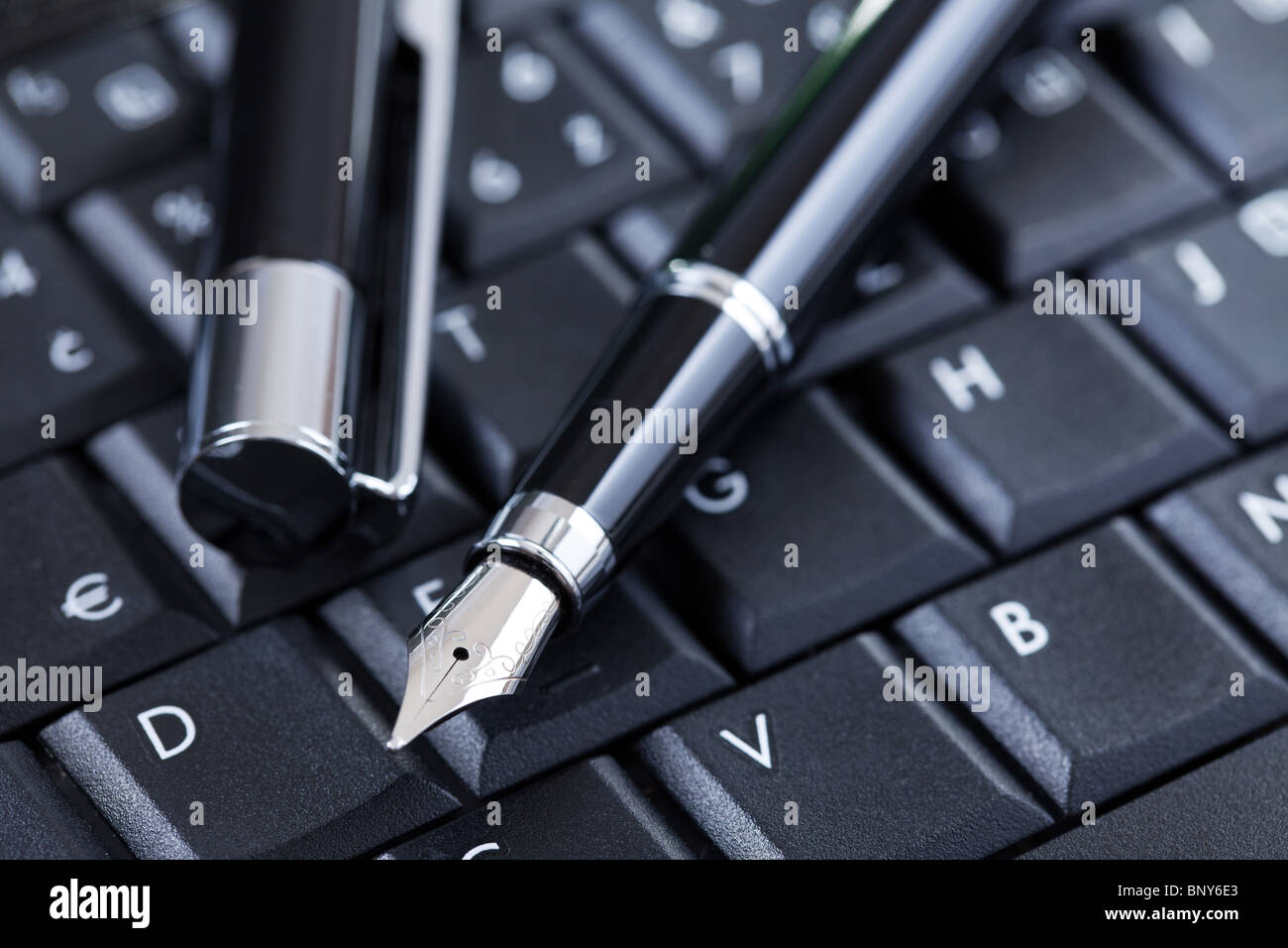 the luxury black pen on computer keyboard Stock Photo - Alamy