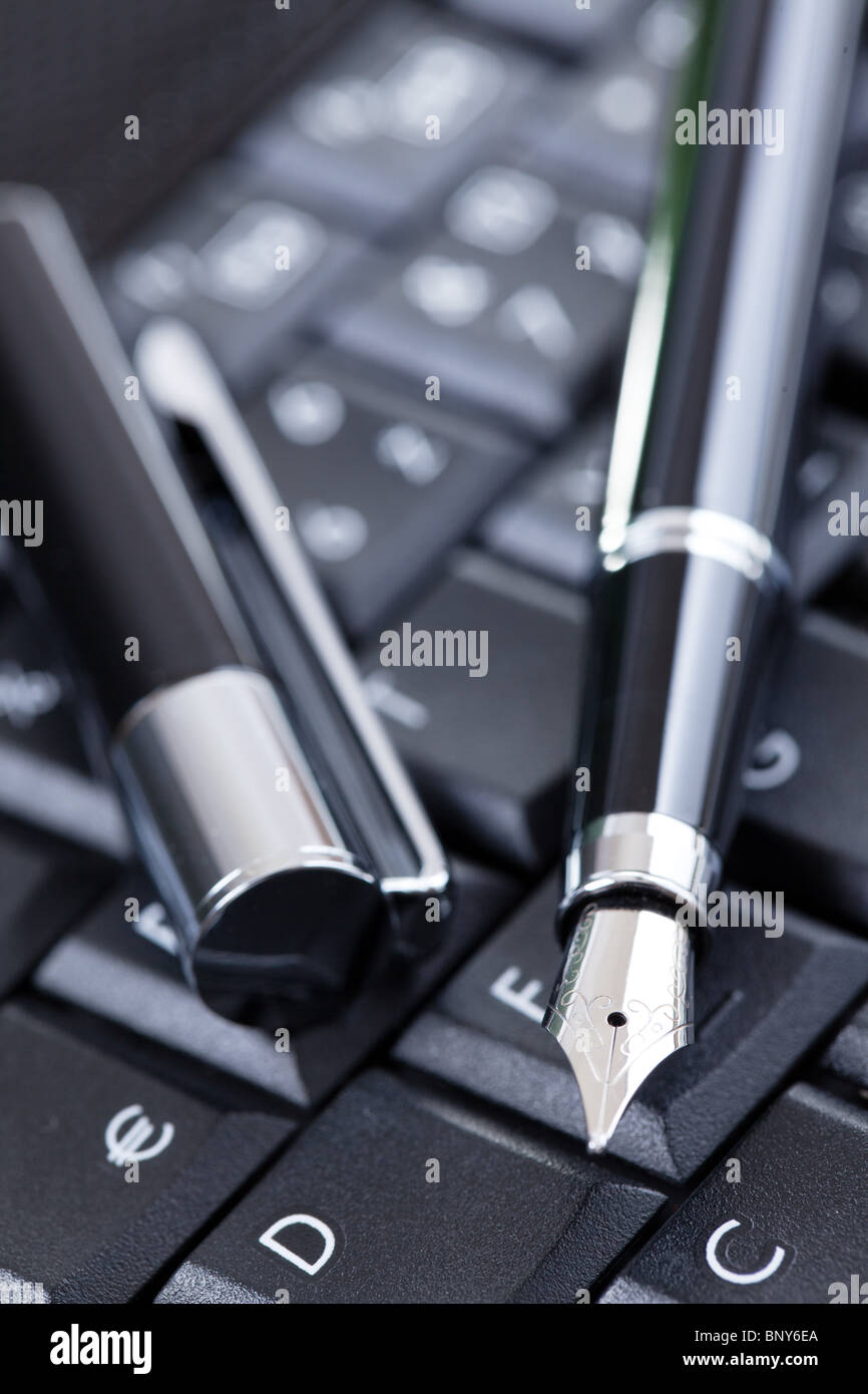 the luxury black pen on computer keyboard Stock Photo - Alamy