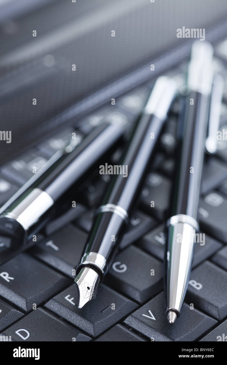 the luxury black pen on computer keyboard Stock Photo - Alamy