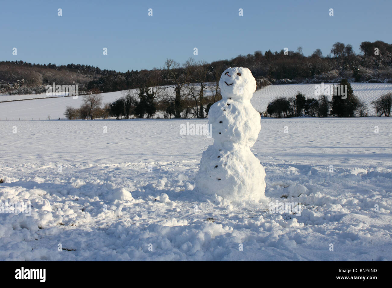 Snowman in field with Chiltern Hills behind at Mill End, Hambleden ...