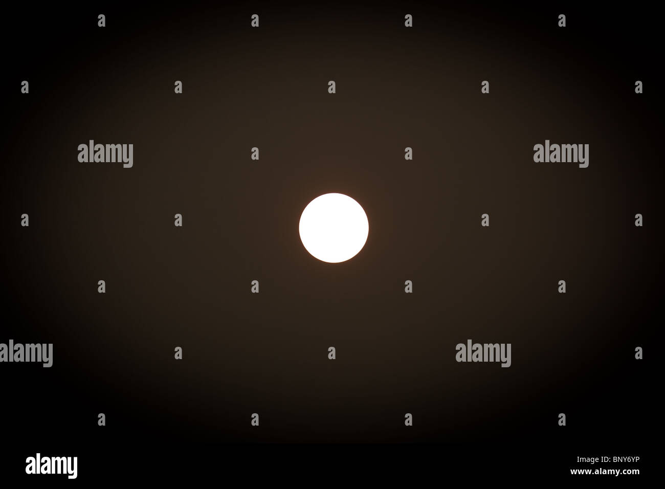 Smoke in the sky. The sun through smoke Stock Photo - Alamy