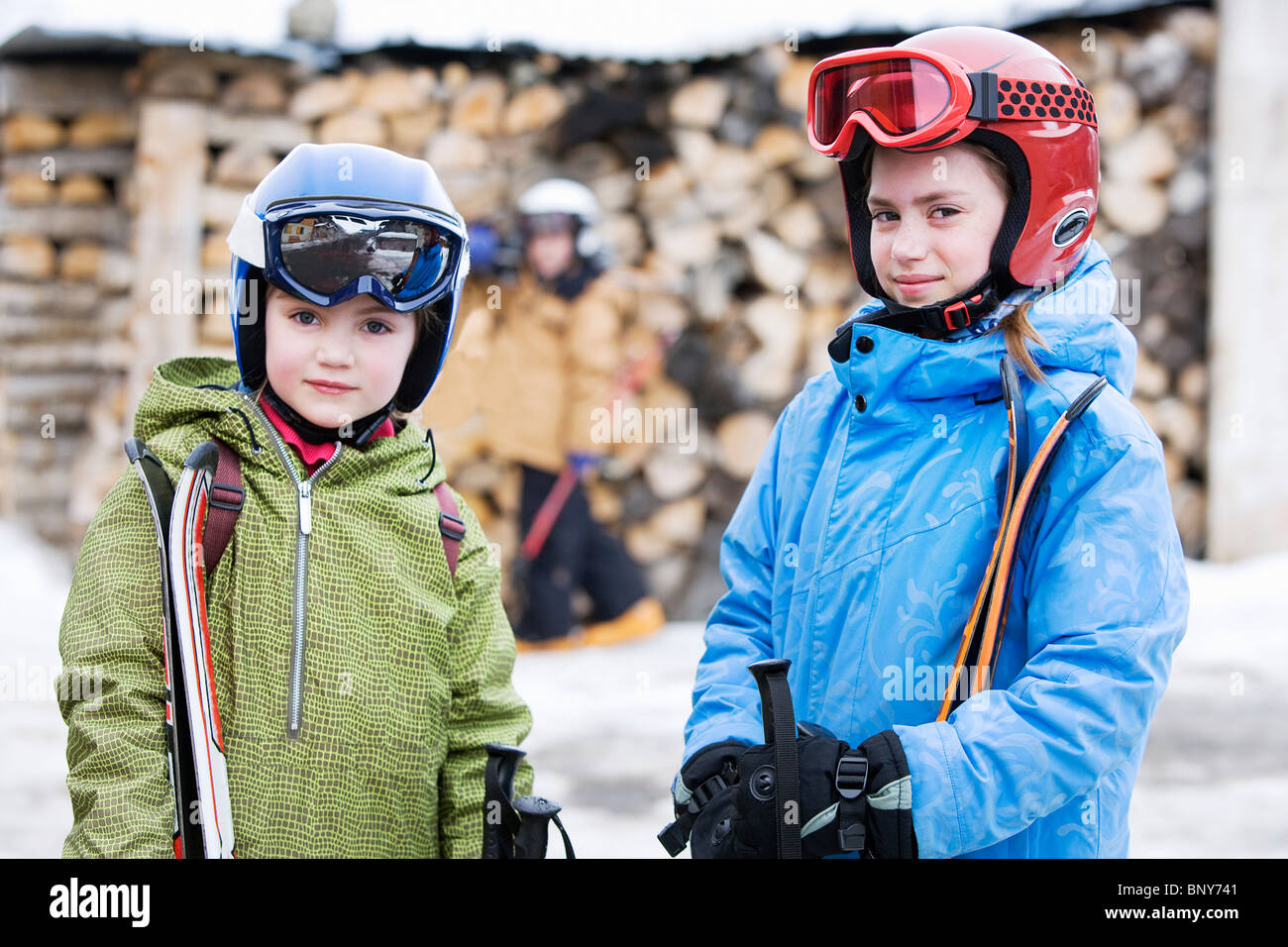 Kids with Skis by log pile Stock Photo - Alamy