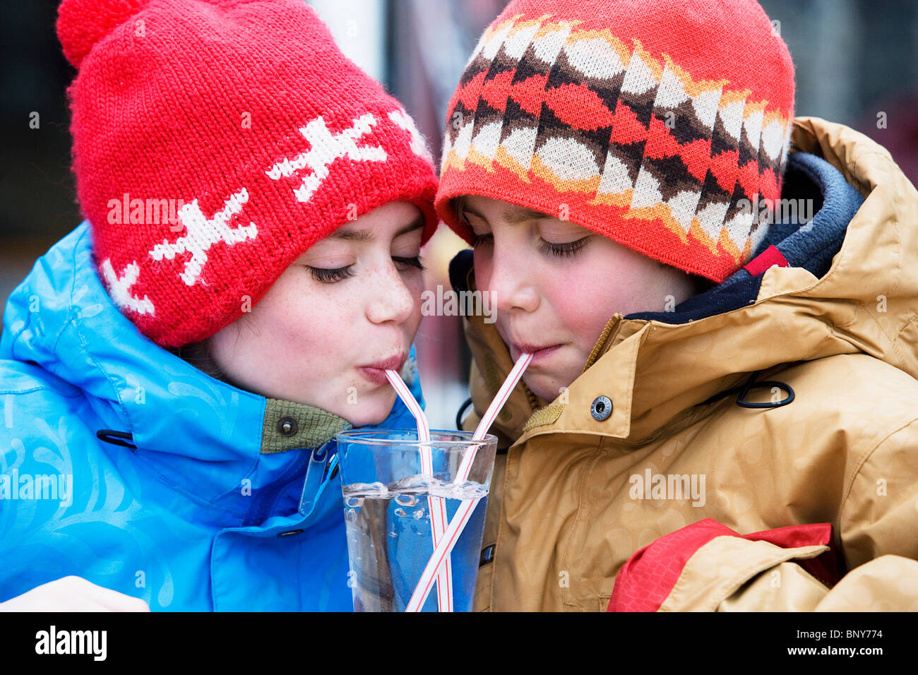 Two children drinking glass of water Stock Photo - Alamy