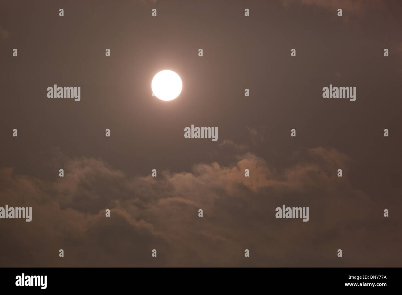 Smoke in the sky. The sun through smoke Stock Photo - Alamy