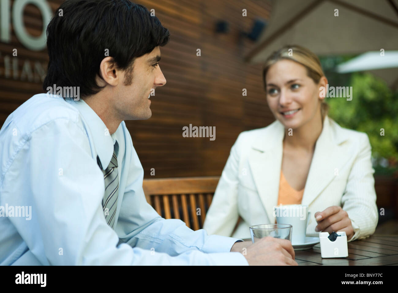 Couple relaxing together in outdoor cafe Stock Photo - Alamy