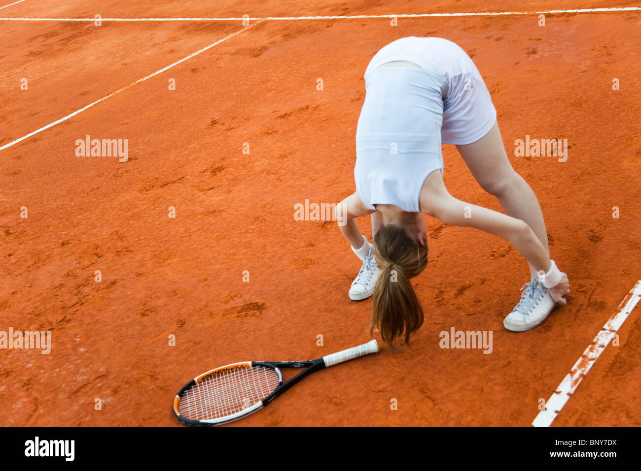 Tennis player stretching before game Stock Photo - Alamy