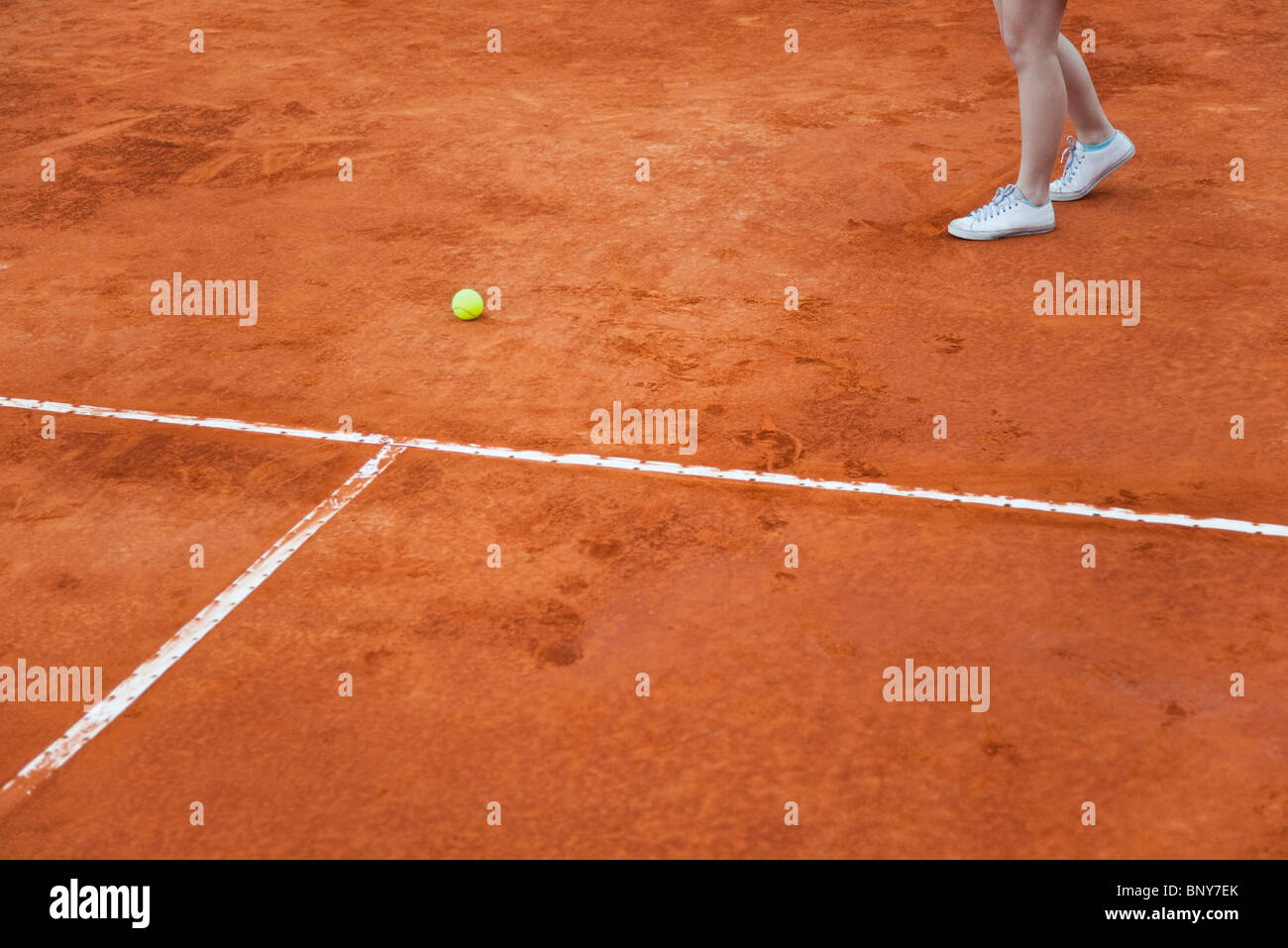 Tennis player approaching missed ball, cropped Stock Photo - Alamy