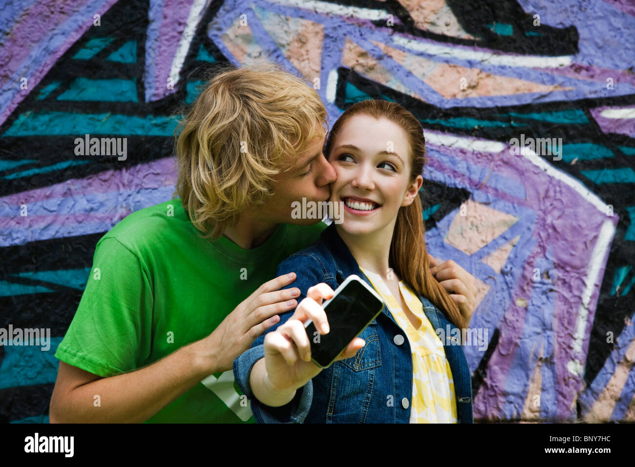 Grinning couple kissing hi-res stock photography and images - Alamy