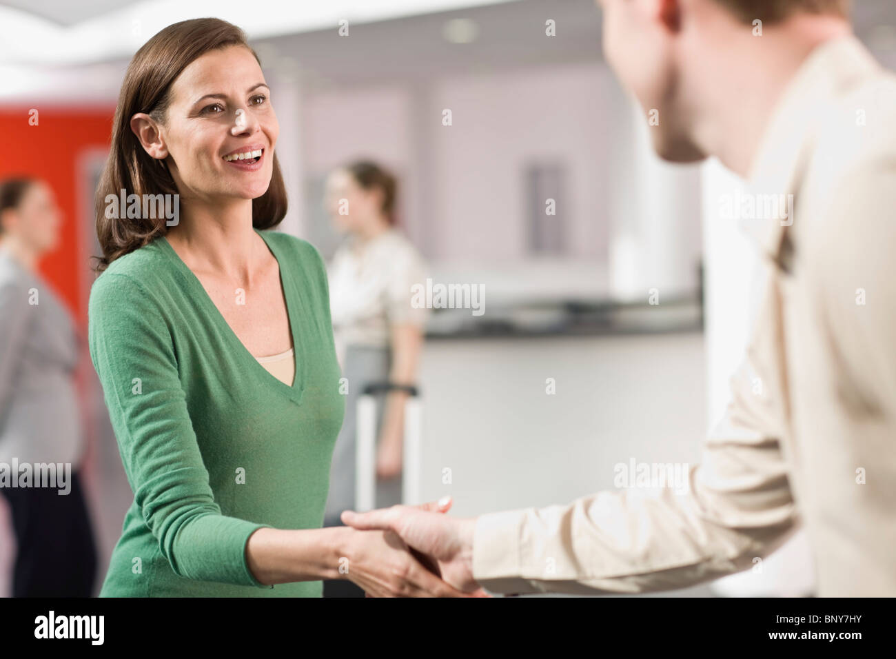 Woman and man shaking hands Stock Photo - Alamy