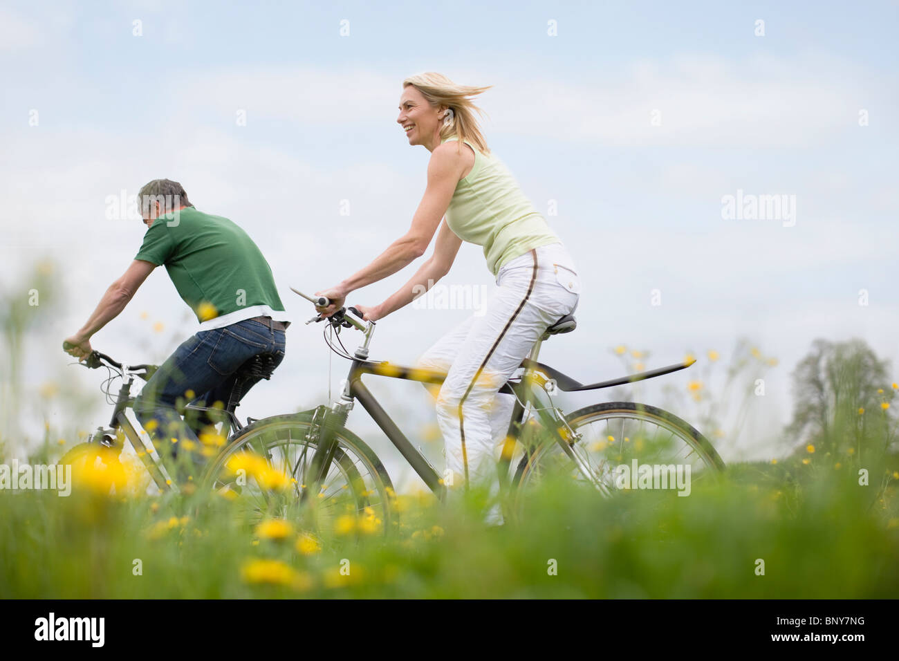 Couple riding bikes Stock Photo - Alamy