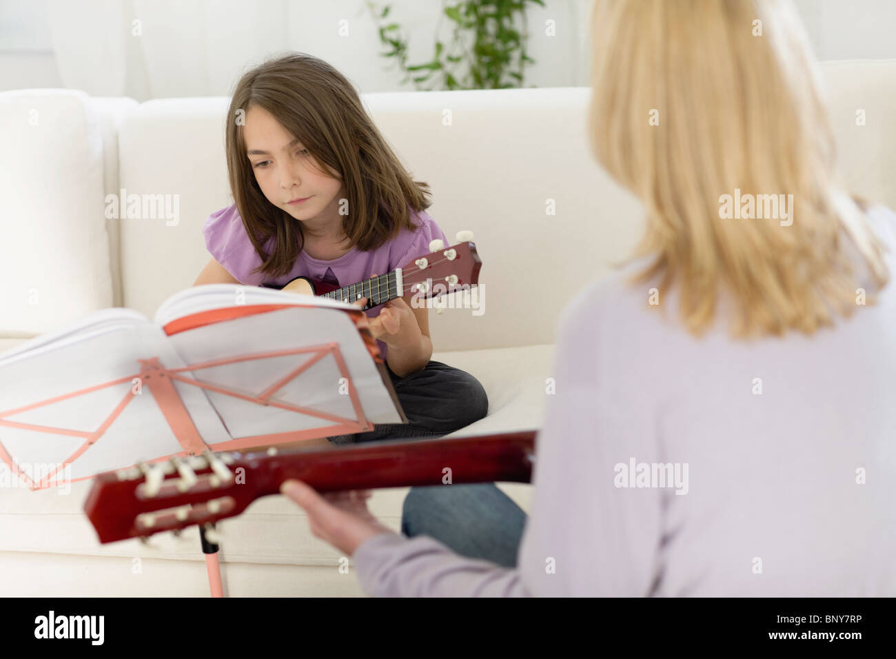 Girl having a lesson on the guitar Stock Photo - Alamy