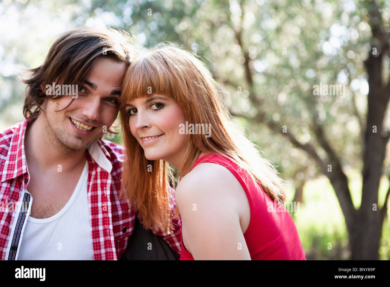 Young couple leaning heads together Stock Photo - Alamy