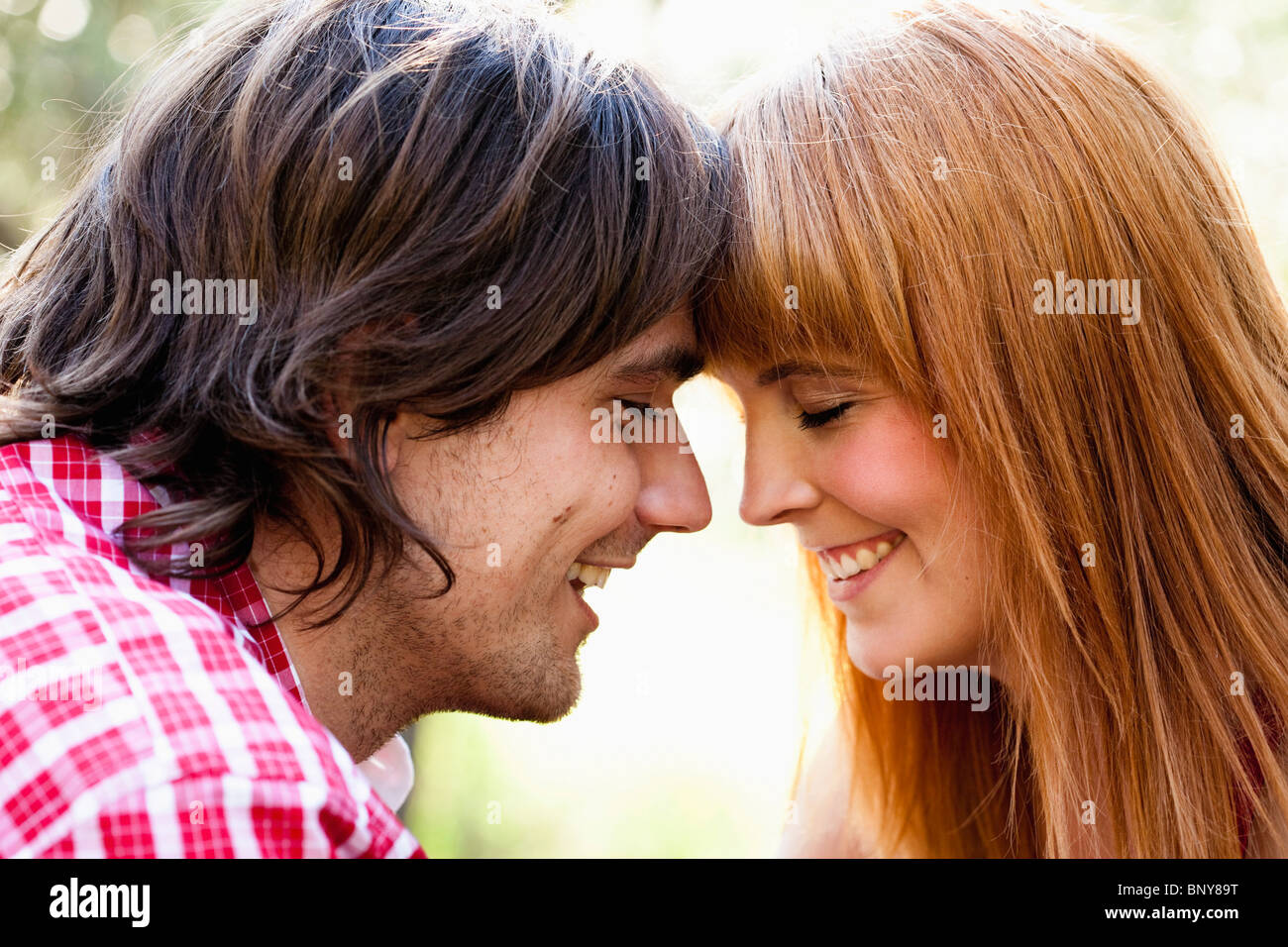 Young couple facing Stock Photo - Alamy