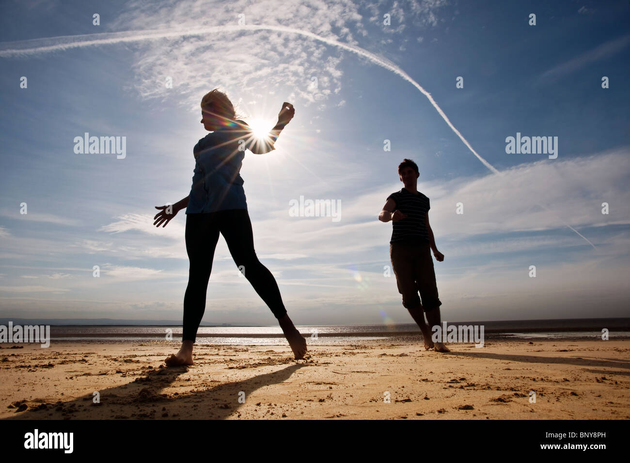 two people running on beach Stock Photo - Alamy