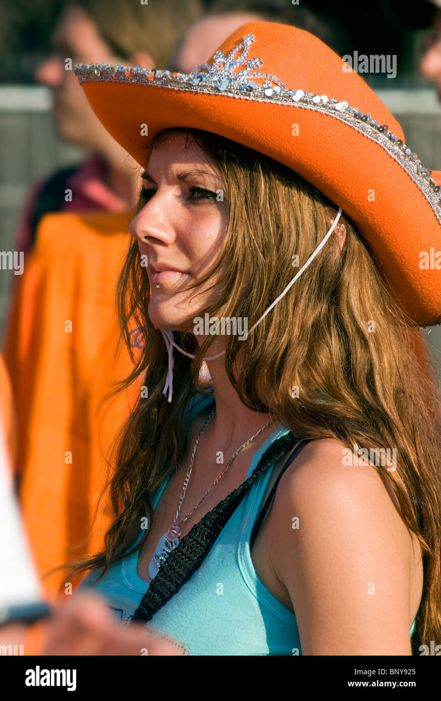 Portrait of a young Dutch woman wearing a patriotic orange cowboy hat ...