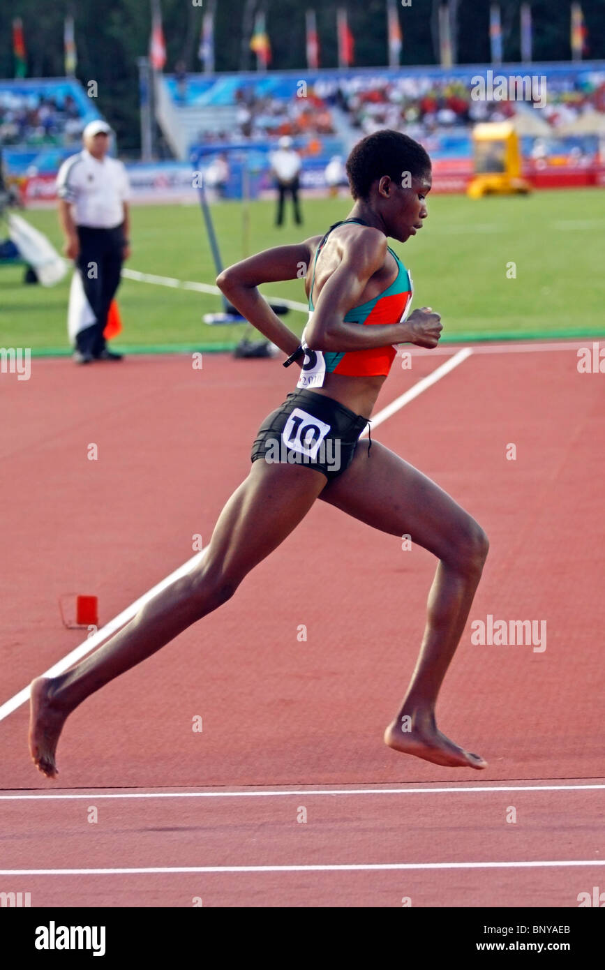 Alice Aprot Nawowuna of Kenya runs the 5000 metres in her bare feet at ...