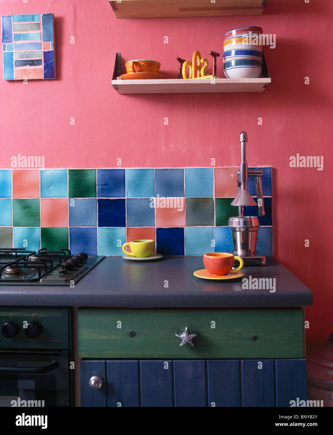 Small shelf on wall above colorful blue and pink tiles ceramic tiled ...