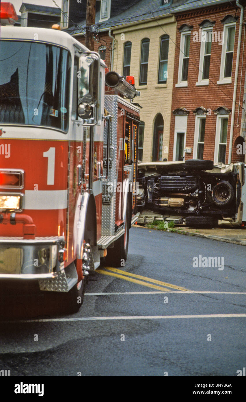 Over turned car at accident scene, police and fire truck Stock Photo ...