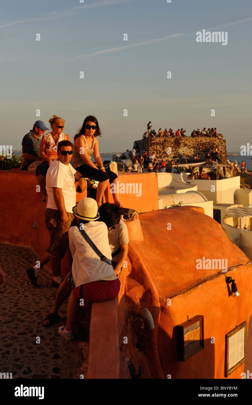 Crowds of tourists gathered to see the sunset at Oia on the Greek ...