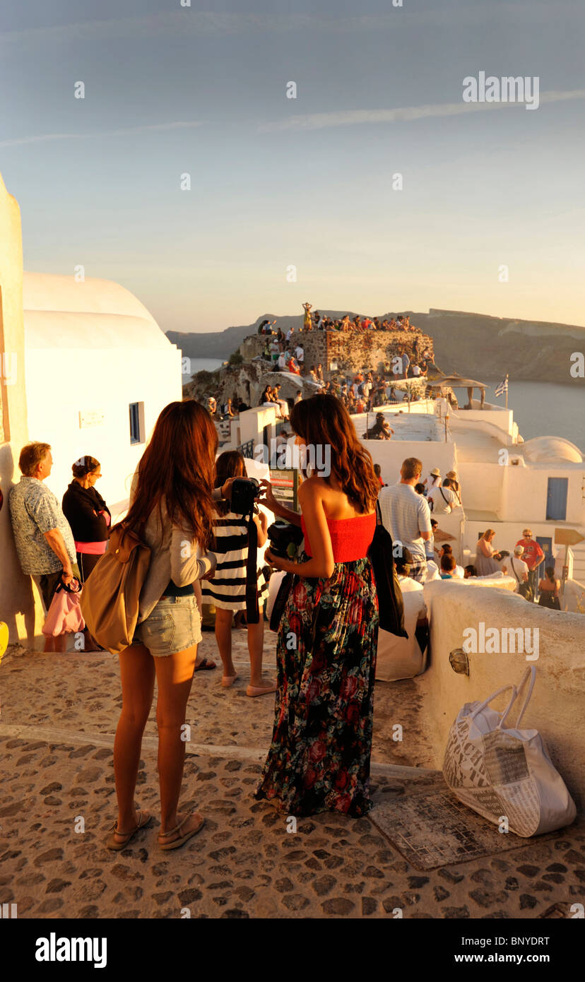 Crowds of tourists gathered to see the sunset at Oia on the Greek ...