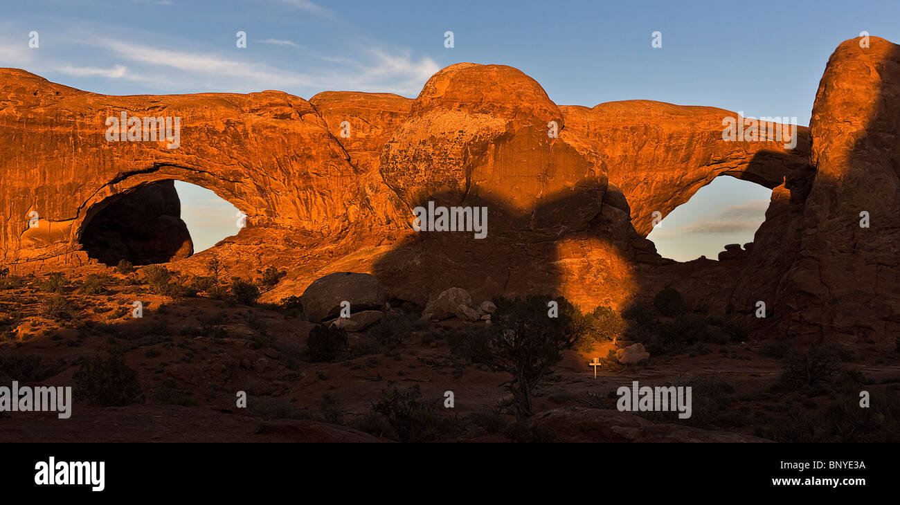Sunset light bathes the red rock formation of North and South Windows ...
