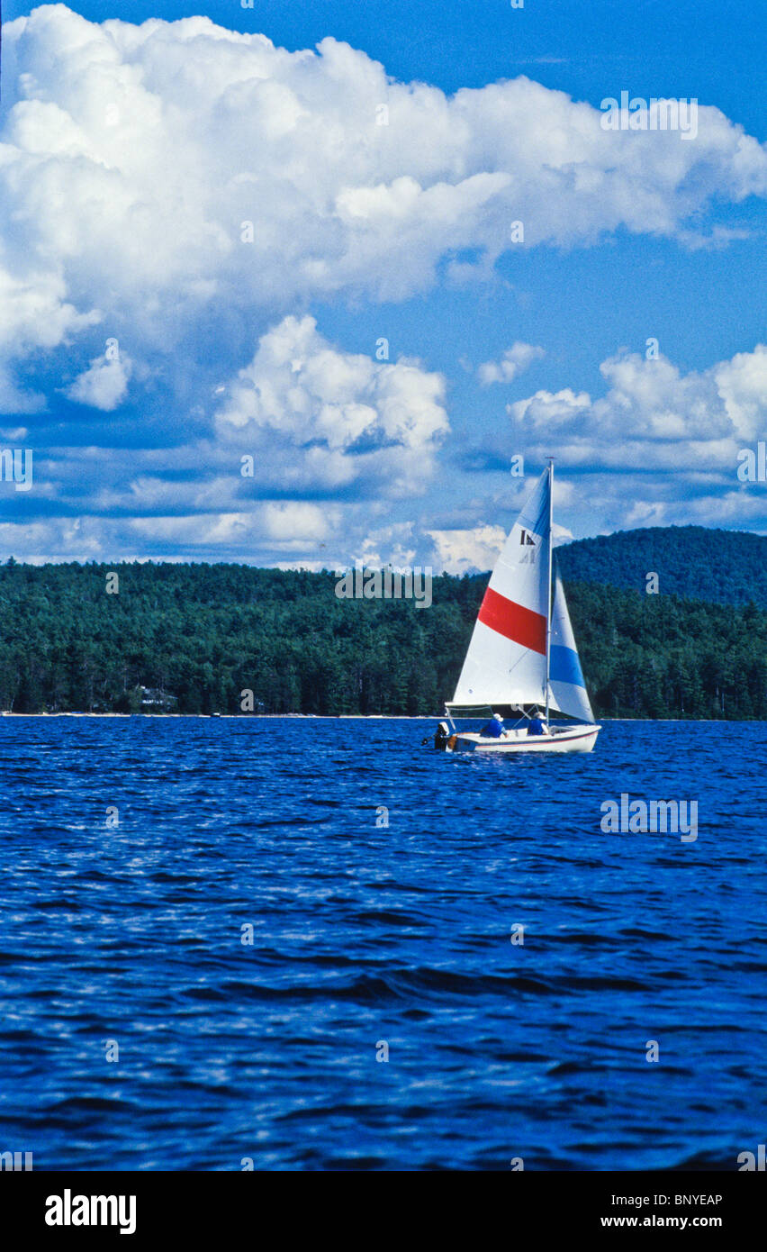 Two people, man woman navigate small sail boat Stock Photo - Alamy