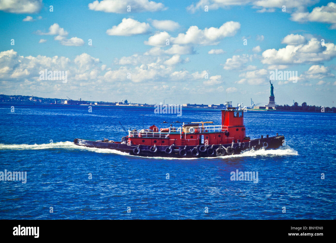 Commercial tug boat in Manhattan harbor Beautiful blue sky white puffy ...