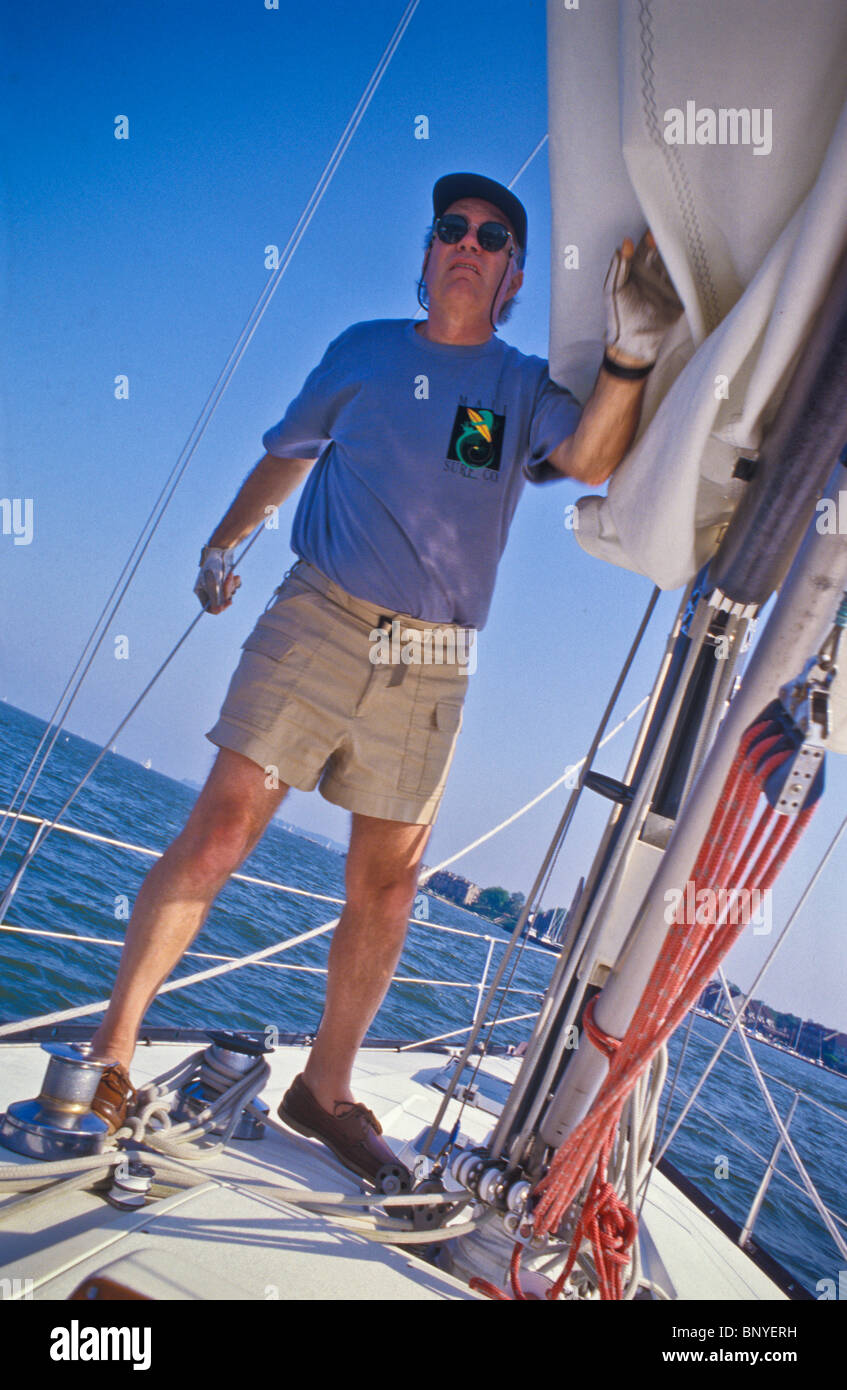 Captain crew check set of sail, sailboat in bay Stock Photo - Alamy
