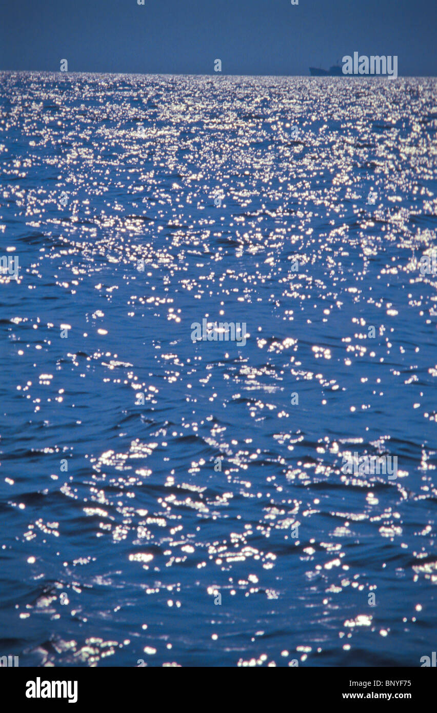 Ship passing in the night, ocean ripple waves freighter horizon blue ...