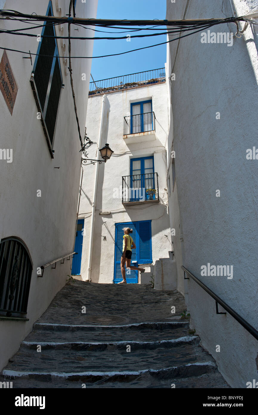 Tourist walking in the narrow streets in the town of Cadaques, Girona ...