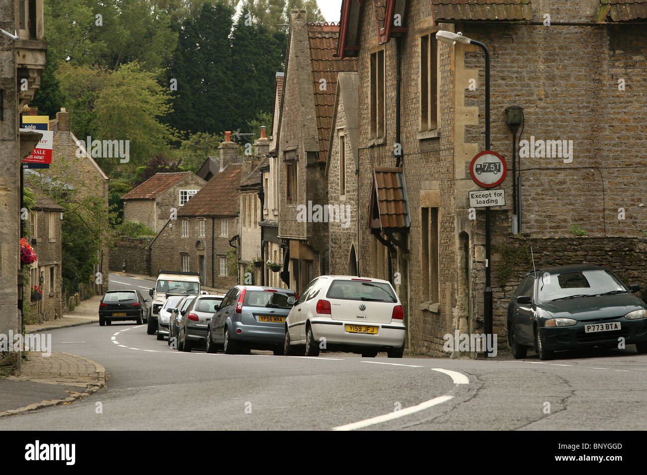 Wiltshire village street with cars parked Stock Photo - Alamy