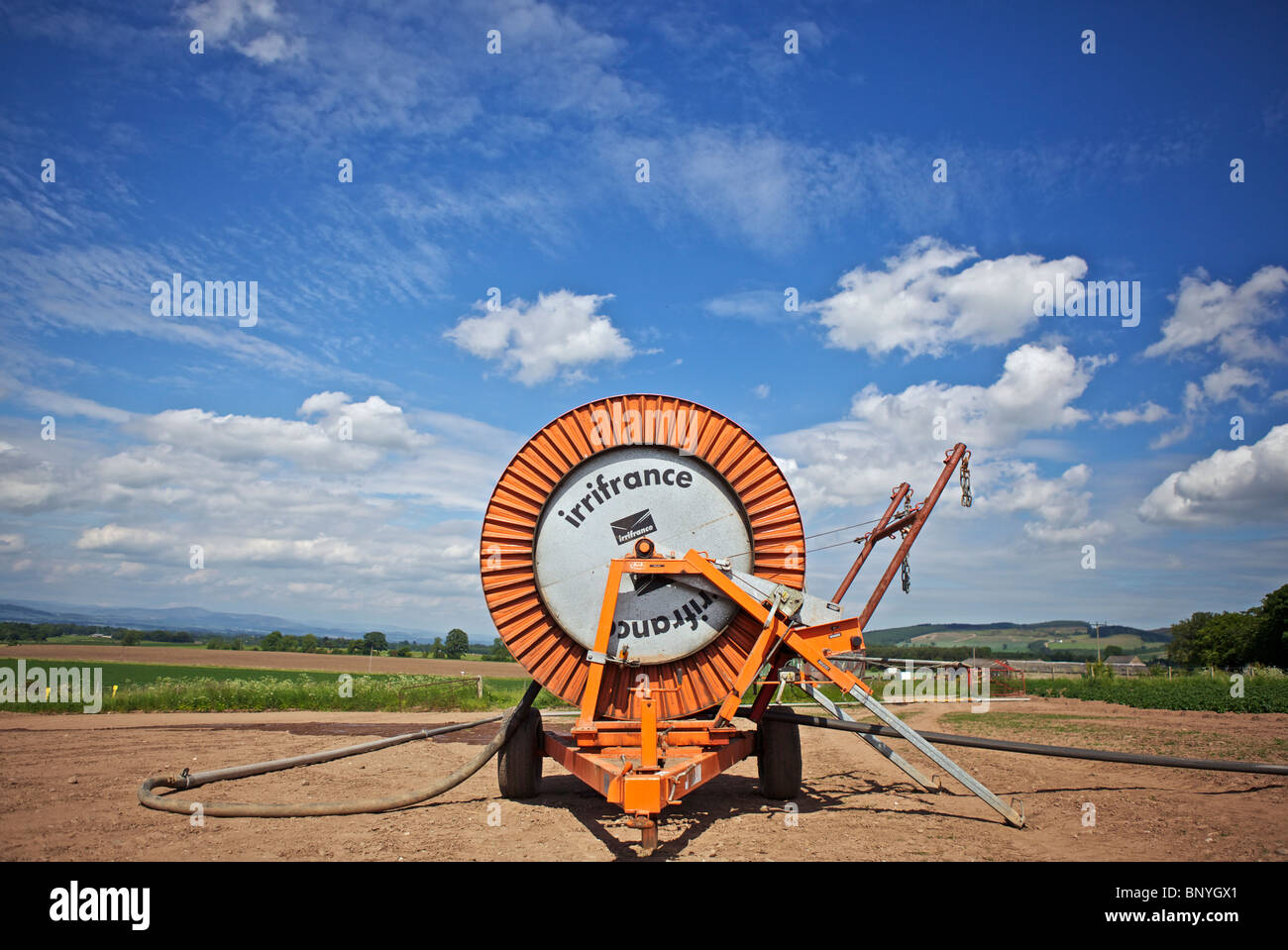 Water irrigator in a field with pipe Stock Photo - Alamy