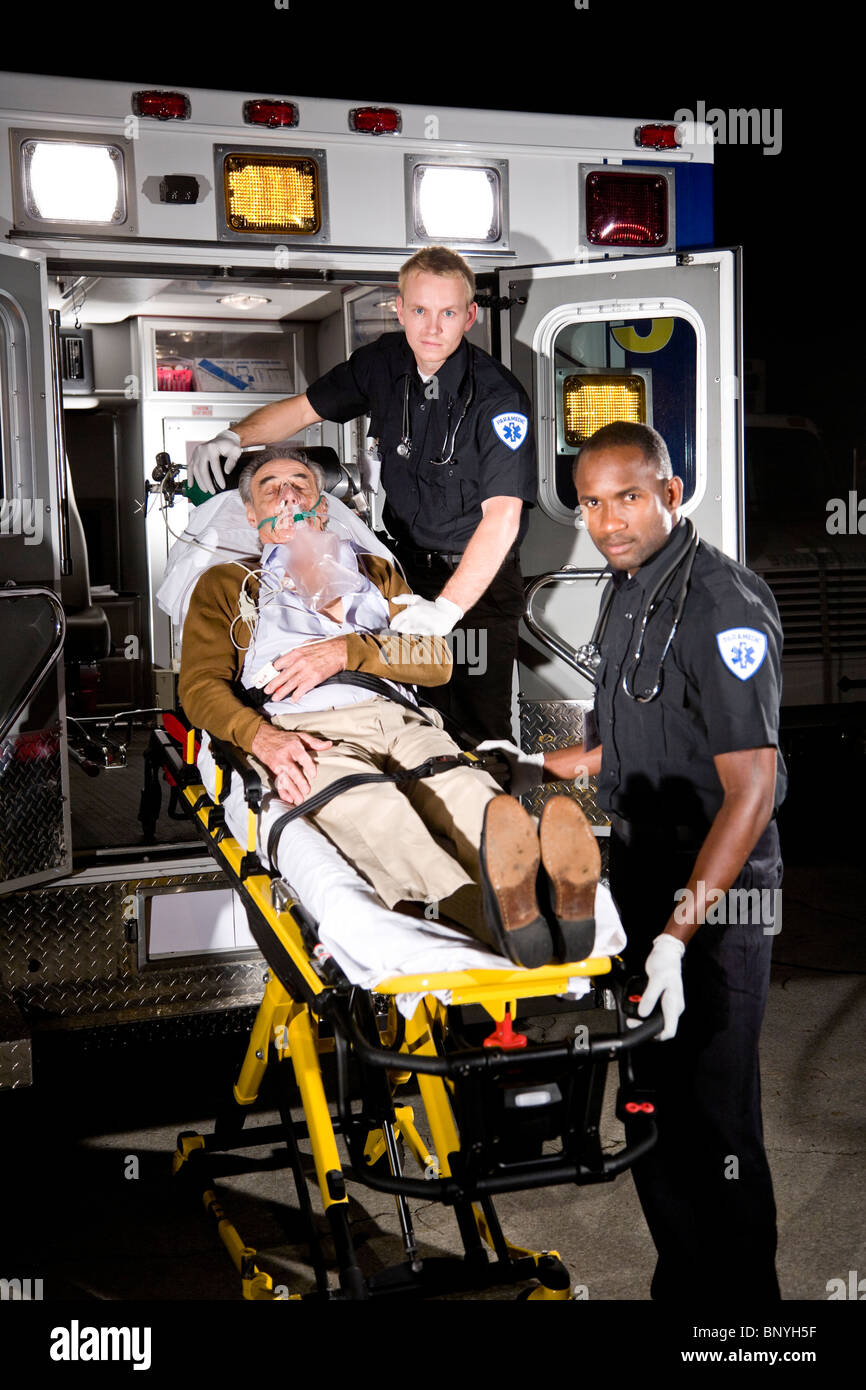 Paramedics caring for elderly patient in ambulance Stock Photo - Alamy