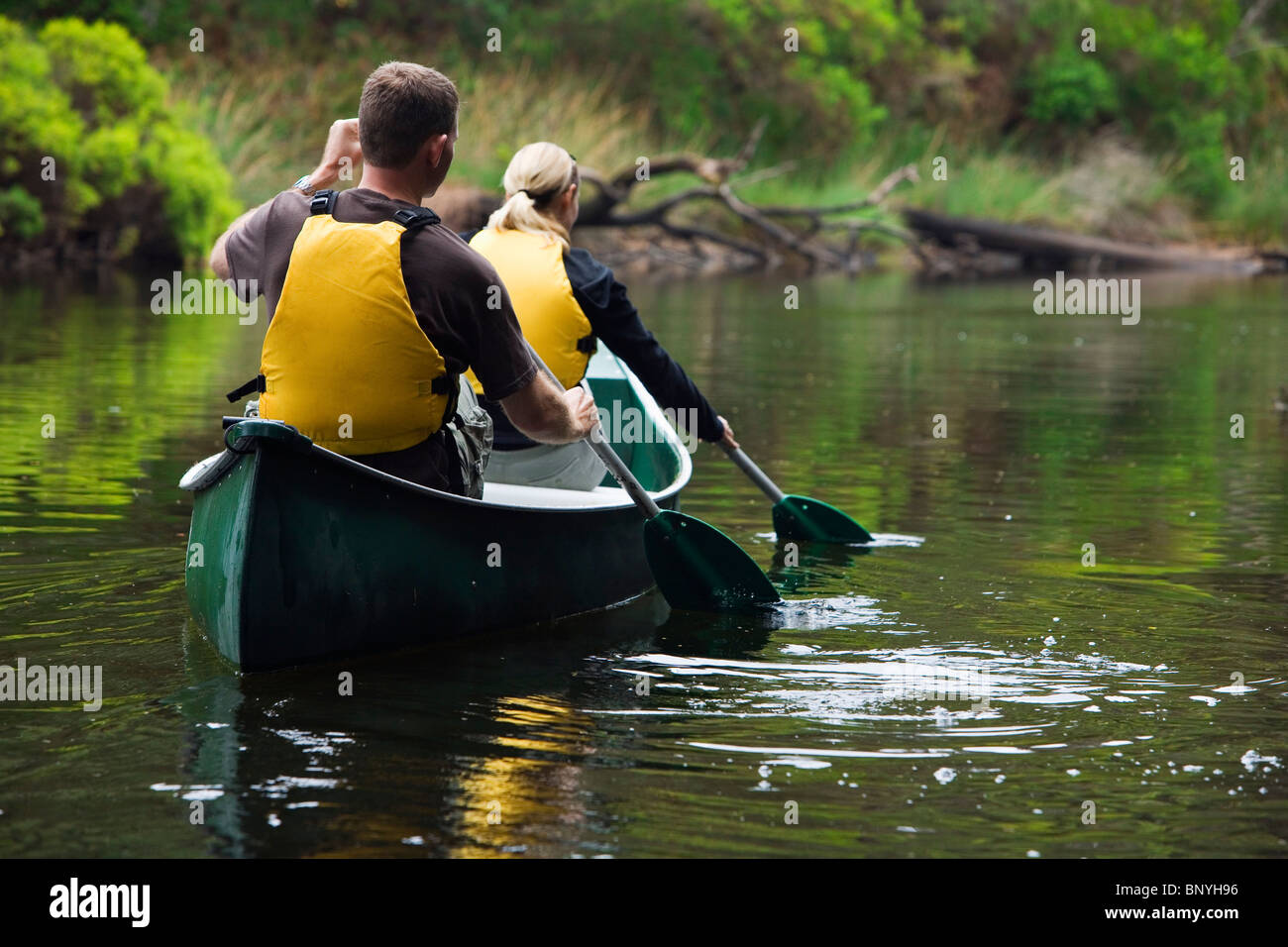 A couple canoeing on the Margaret River, Western Australia, AUSTRALIA ...