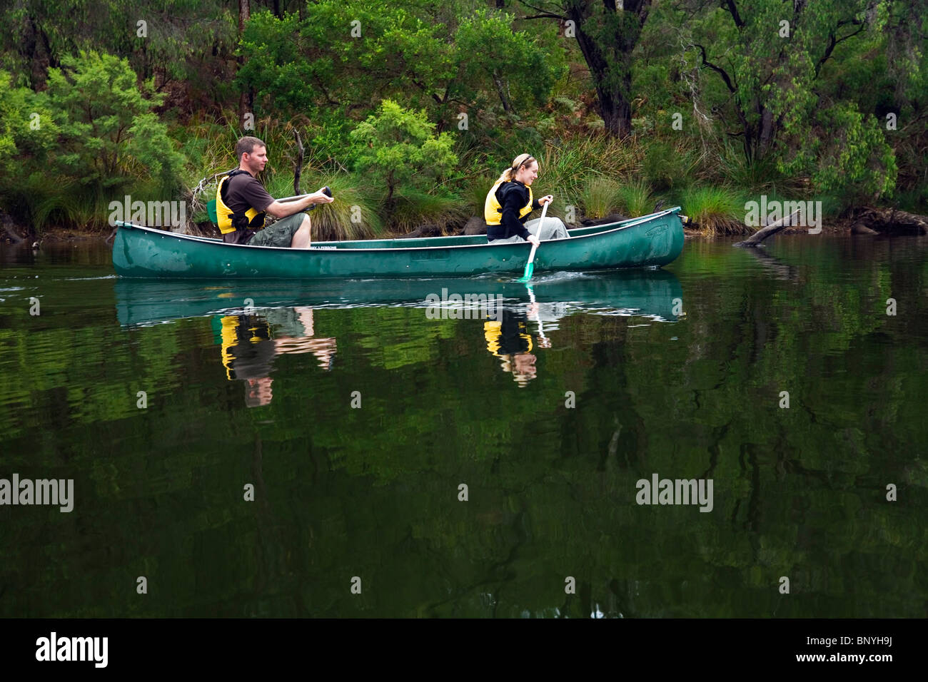 A couple canoeing on the Margaret River, Western Australia, AUSTRALIA ...