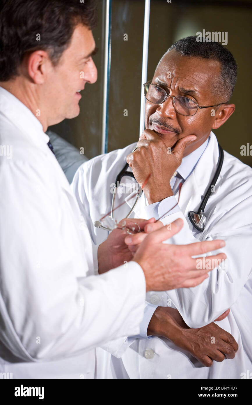 Two doctors serious conversation hi-res stock photography and images ...