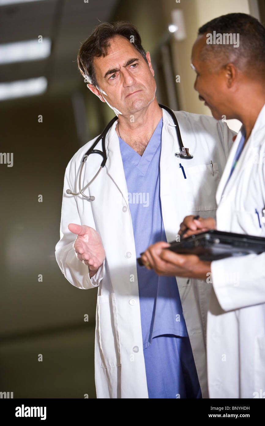 Two doctors serious conversation hi-res stock photography and images ...