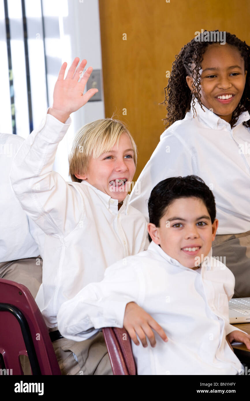 Diverse classroom, boy raising hand Stock Photo - Alamy