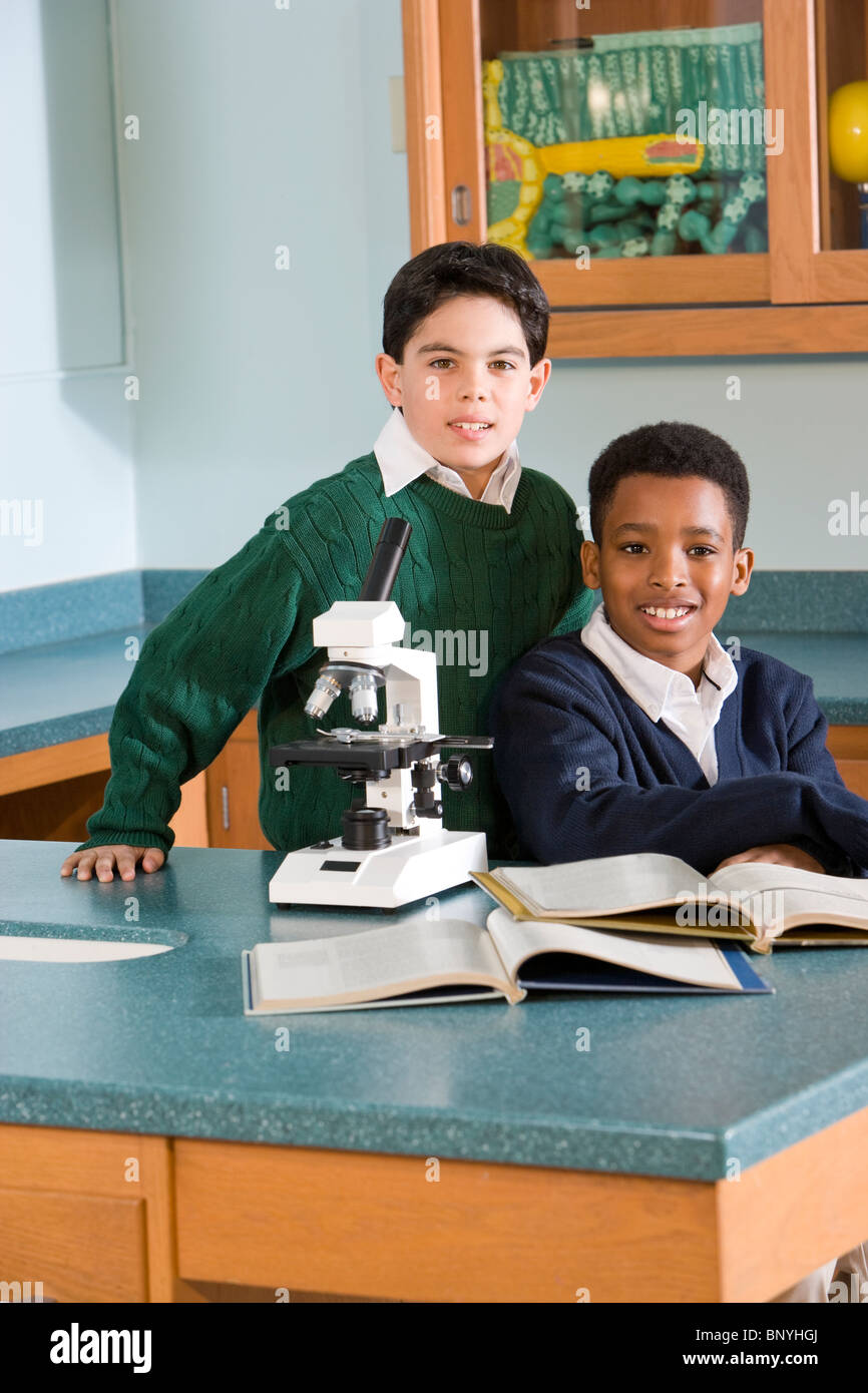 Elementary school boys with microscope in science lab Stock Photo - Alamy