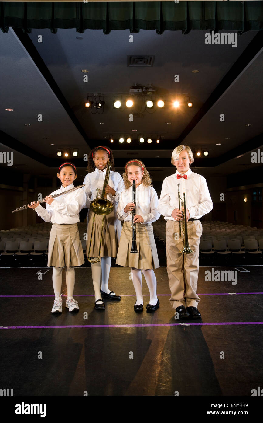 Young students playing musical instruments in school auditorium Stock ...