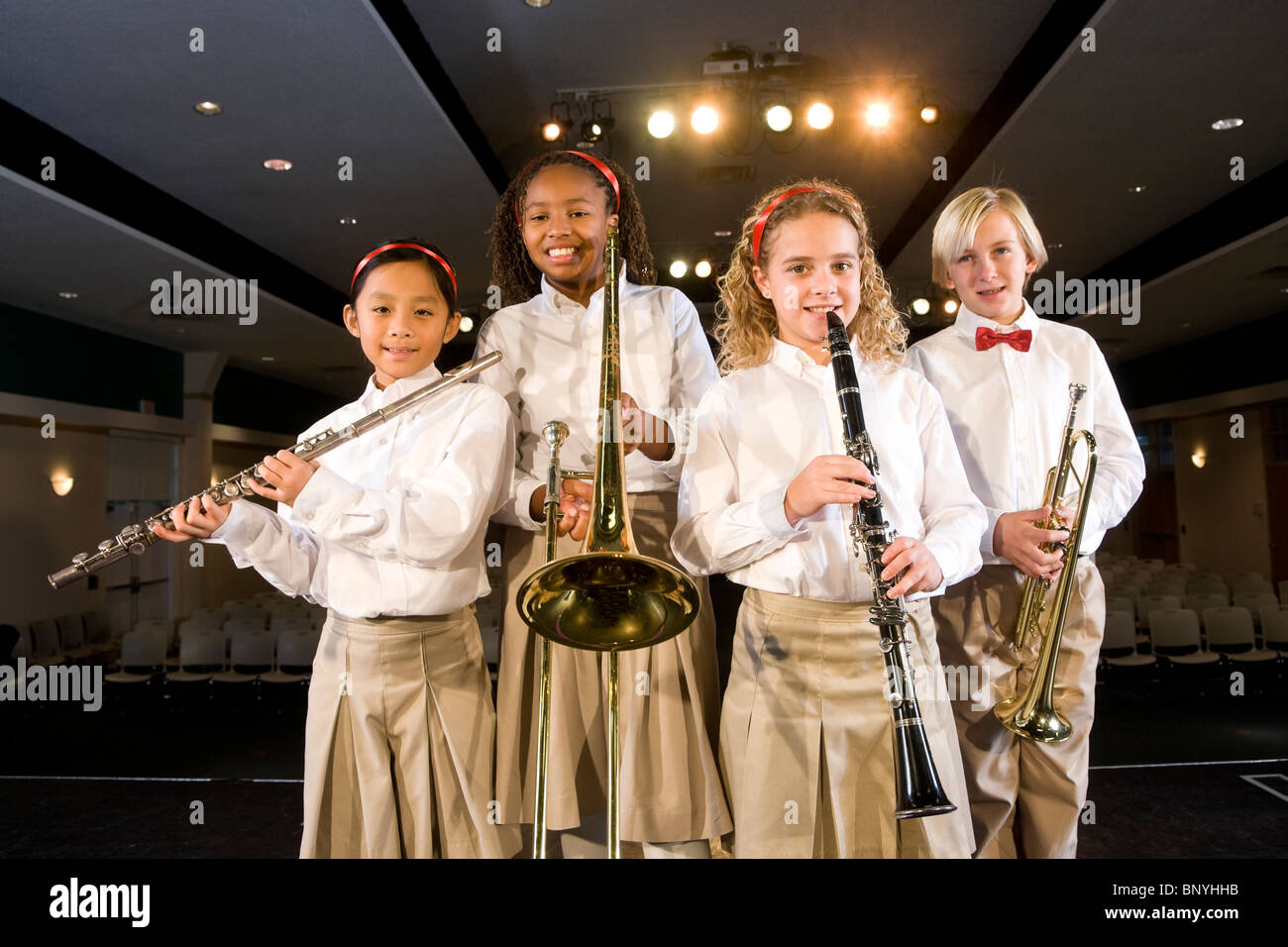 Young students playing musical instruments in school auditorium Stock ...