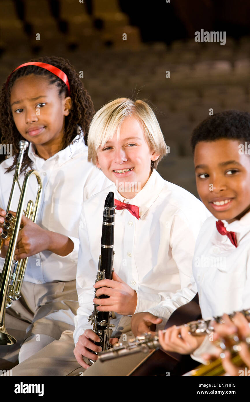 Young students playing musical instruments in school auditorium Stock ...