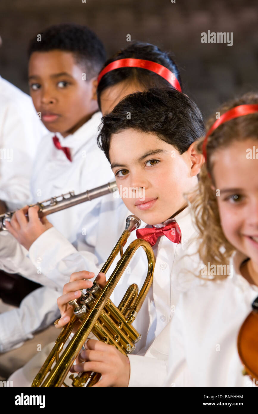 Young students playing musical instruments in school auditorium Stock ...