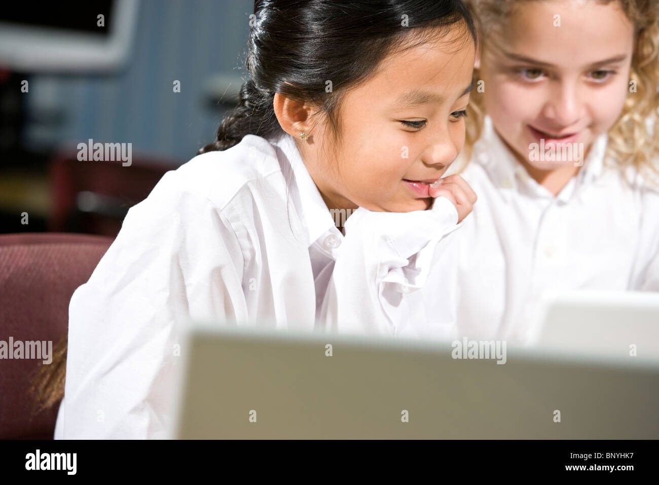 Young multiracial girls with using laptop computers in school Stock ...