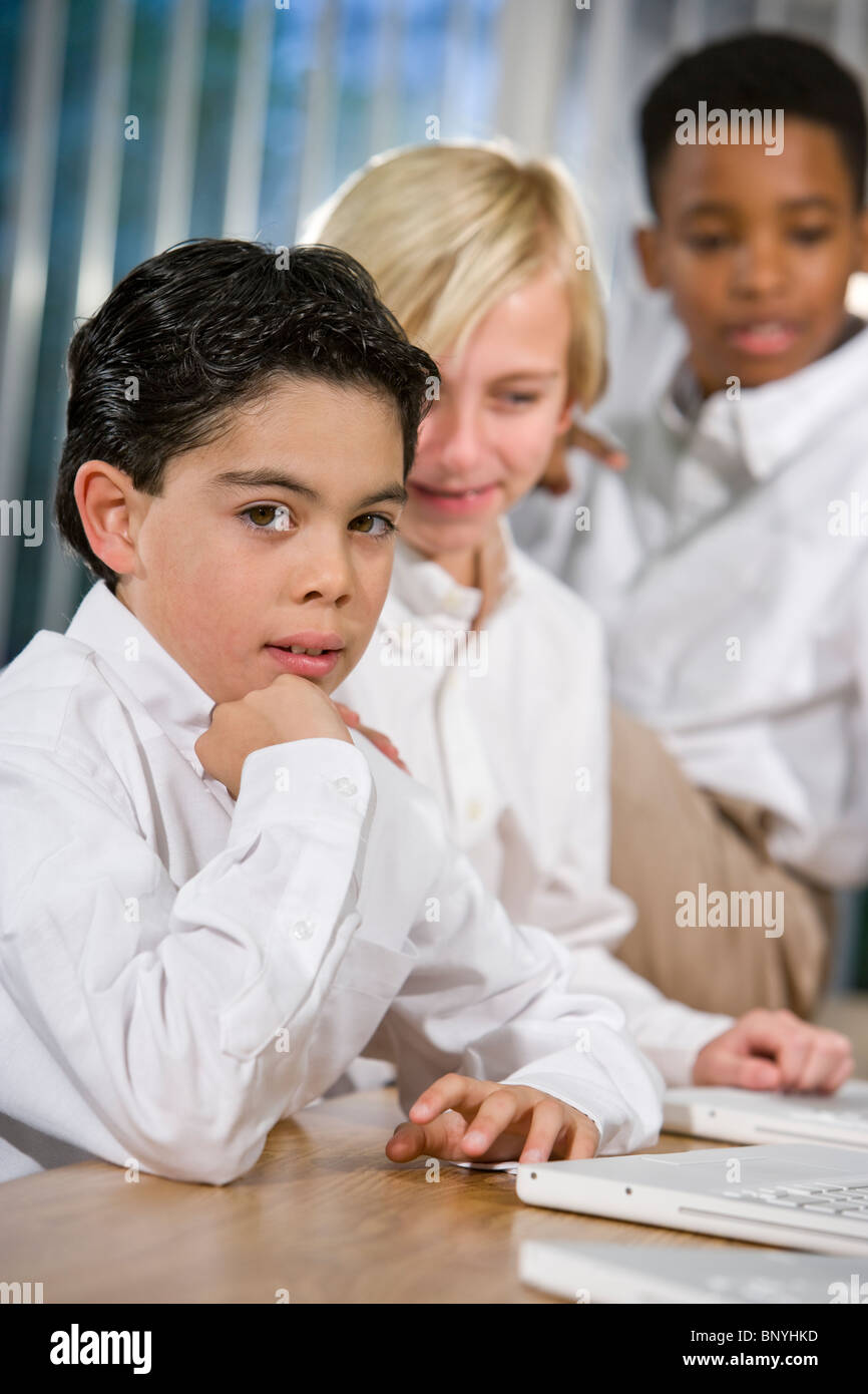 Young multiracial boys with using laptop computers in school Stock ...