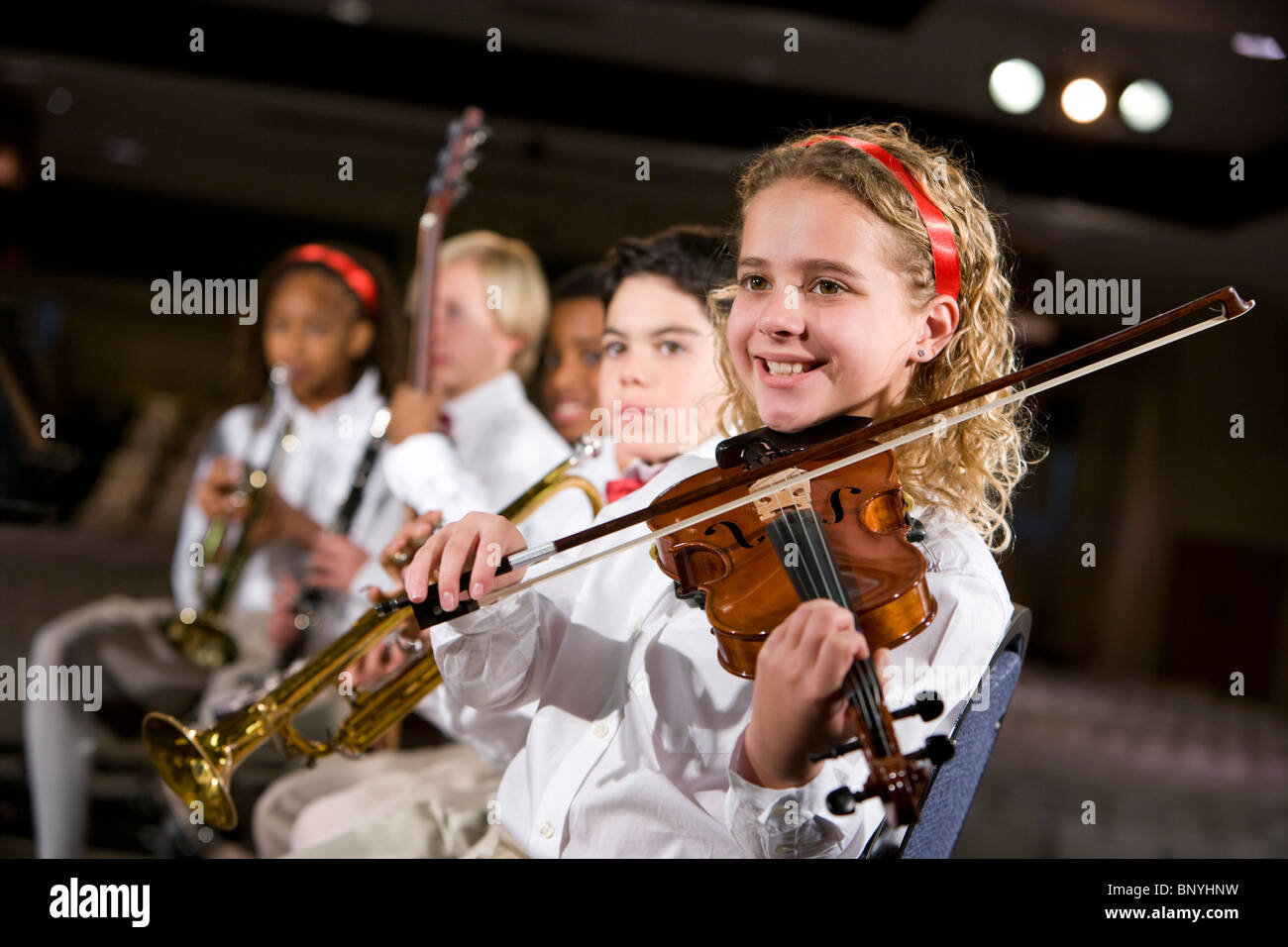 Diverse group of children playing instruments hi-res stock photography ...