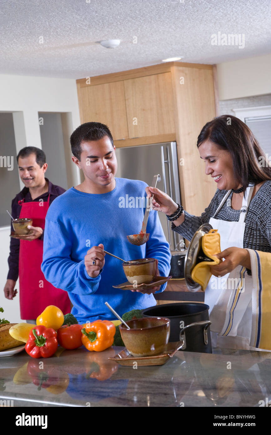 Hispanic family at home in kitchen eating food Stock Photo - Alamy