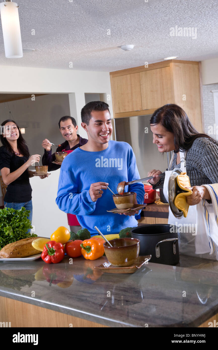 Hispanic family at home in kitchen eating food Stock Photo - Alamy